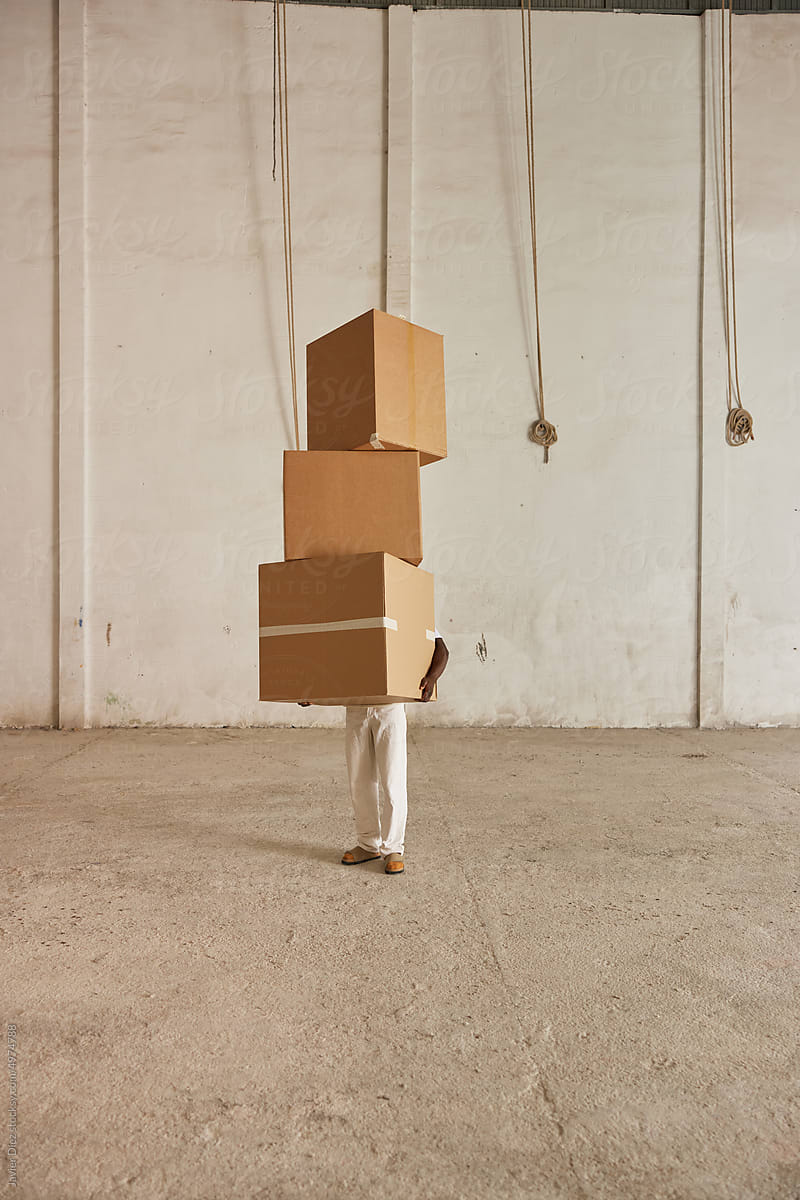 "Black Man Holding Boxes In Warehouse" by Stocksy Contributor "Javier ...