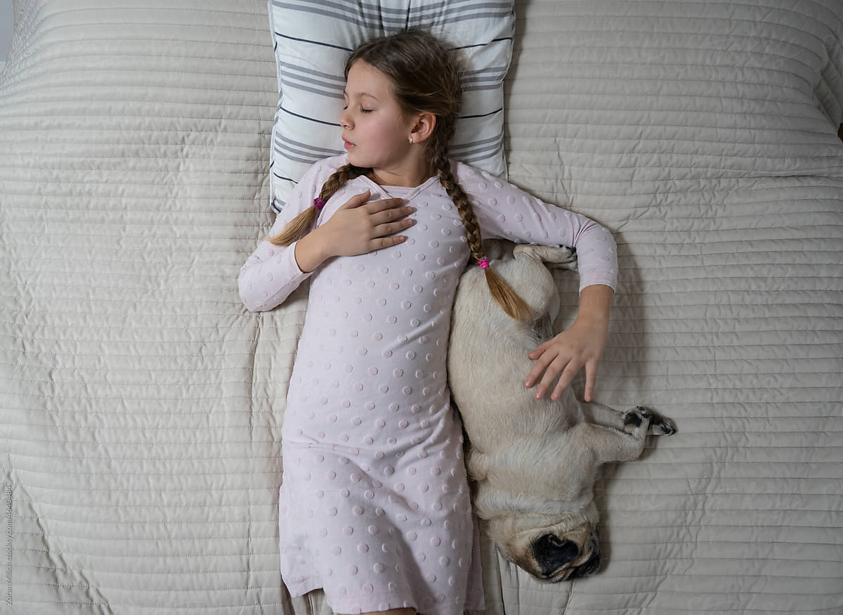 "Child Resting With Pet Pug" by Stocksy Contributor "Zoran Milich ...