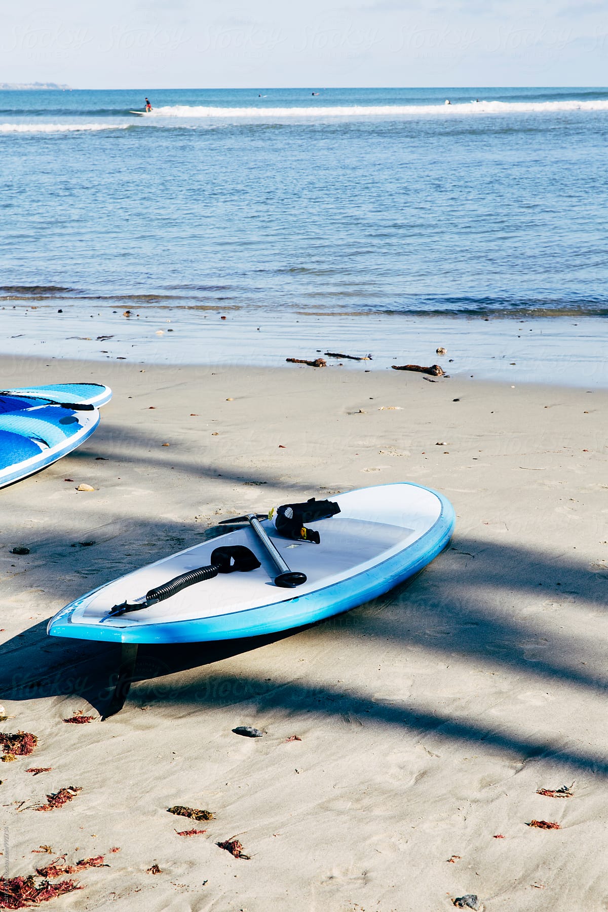 "Paddle Board On Beach" by Stocksy Contributor "Curtis Kim" - Stocksy