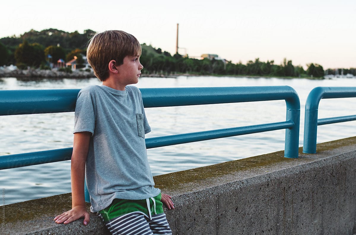 "Boy On Pier" by Stocksy Contributor "Ali Deck" - Stocksy