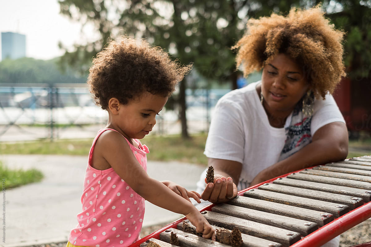 african-mother-and-two-year-old-daughter-playing-together-in-the-park