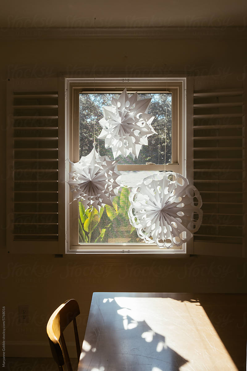 "Paper Snowflakes Christmas Decorations In Home Window" by Stocksy ...