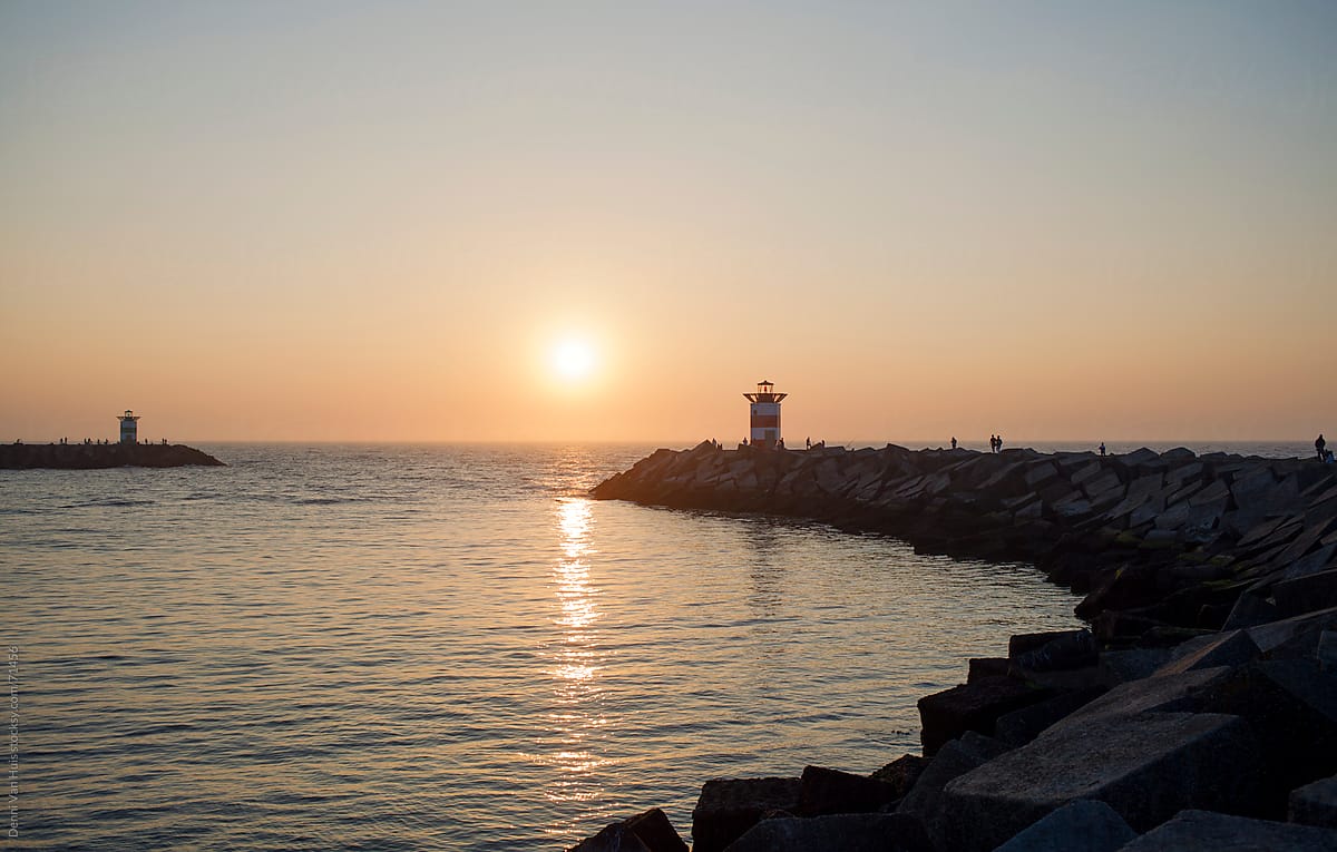 "Two Lighthouses On A Pier At Sunset." by Stocksy Contributor "Denni ...