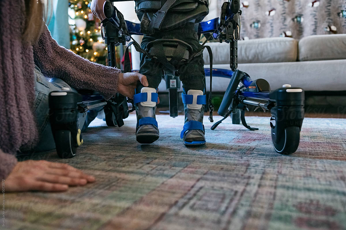 "Child Using Boots And Walker To Learn To Walk" by Stocksy Contributor ...