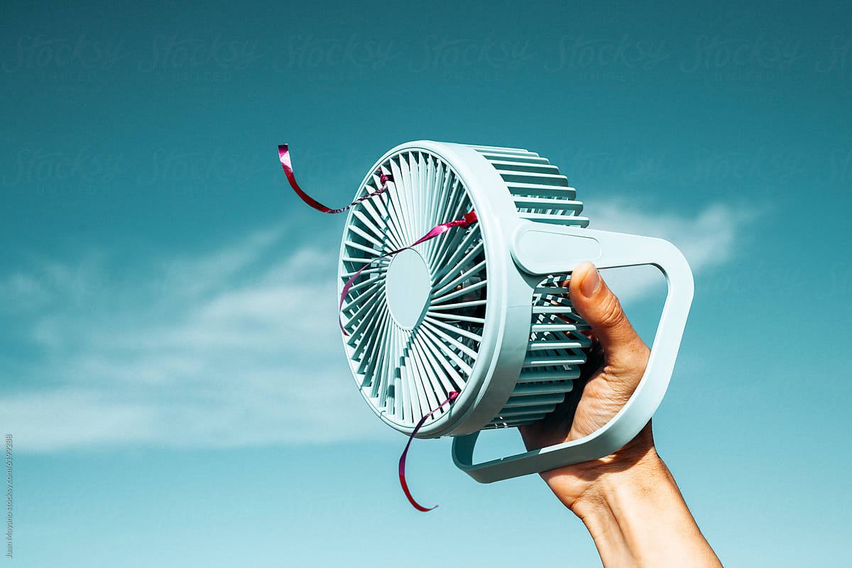"Man Holding An Electric Fan In Use Outdoors" by Stocksy Contributor ...