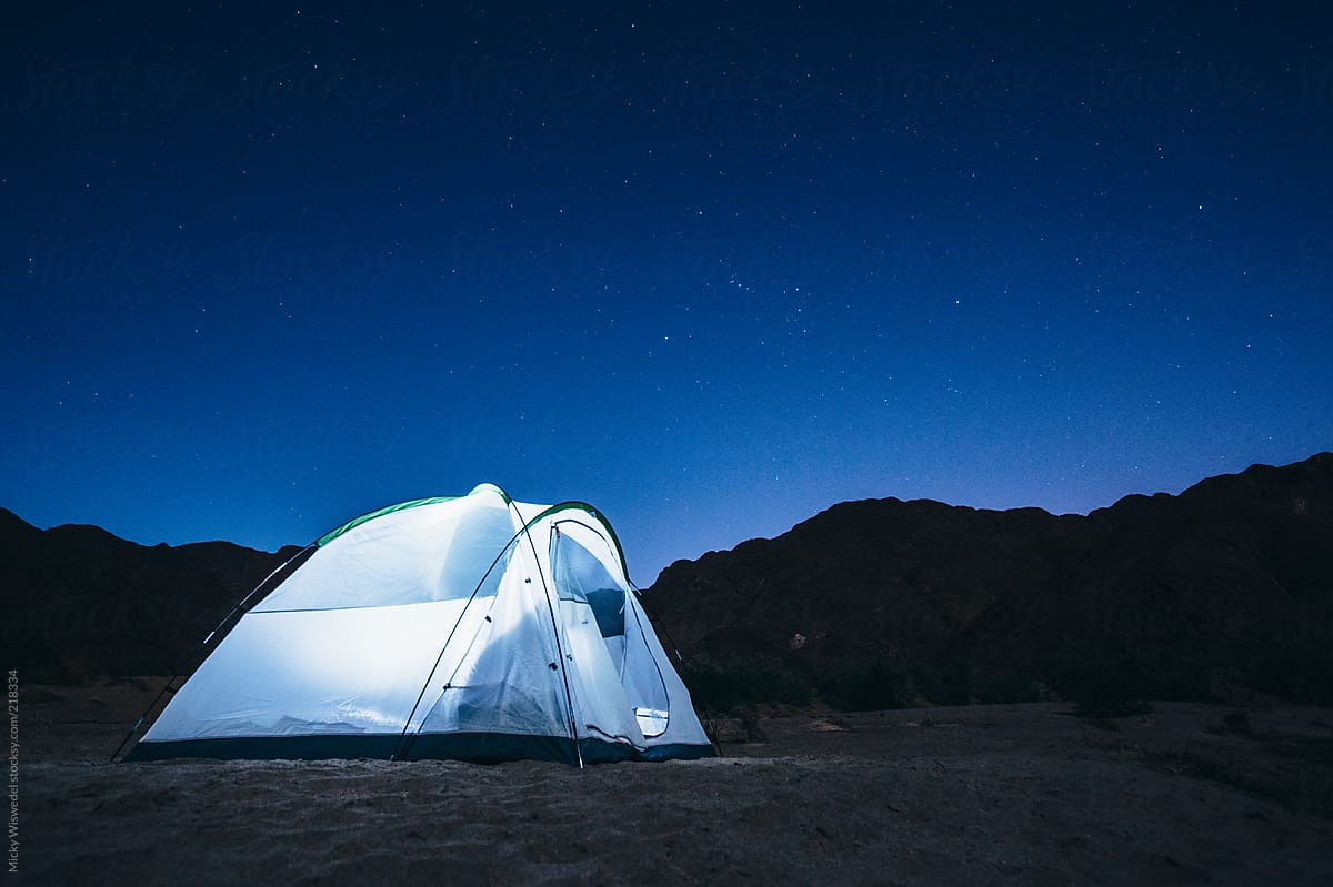 "Camping Tent At Night" by Stocksy Contributor "Juno" - Stocksy