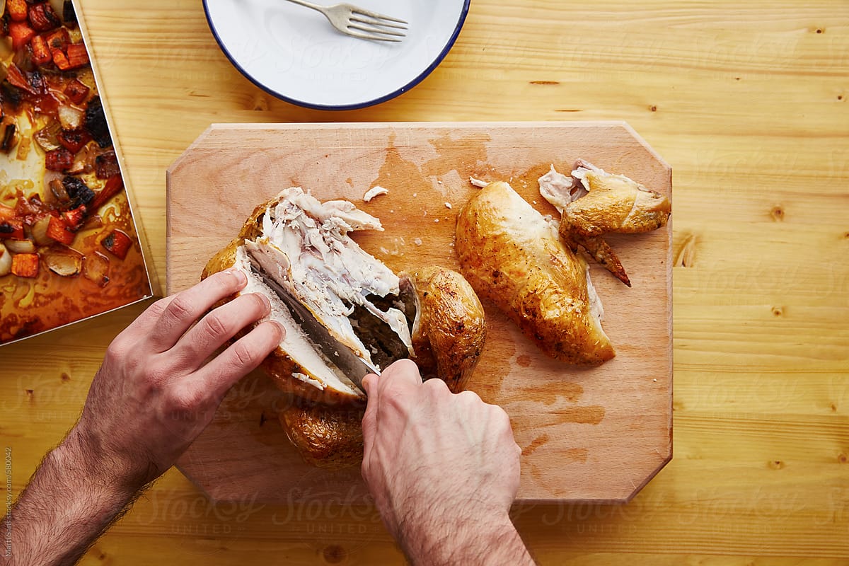 "Cutting Roast Chicken" by Stocksy Contributor "Martí Sans" - Stocksy