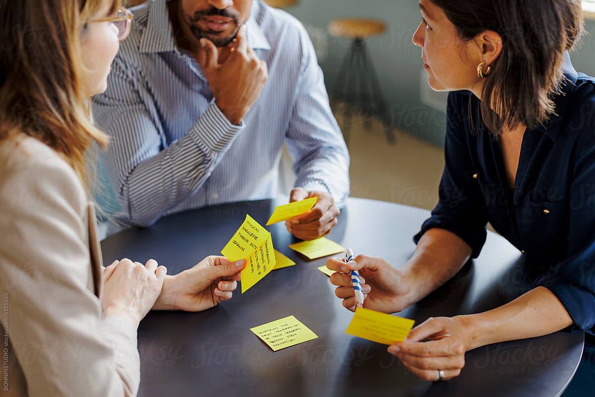 "Formal Business People Having Meeting Using Adhesive Notes At Office ...