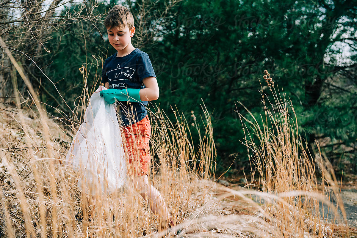 "Young Boy Picking Up Trash For Earth Day" by Stocksy Contributor "Lea ...