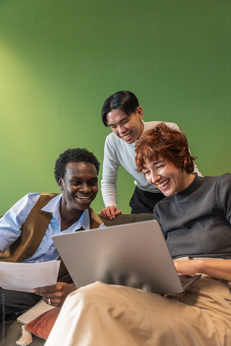 "Happy Team Collaborating On Laptop" by Stocksy Contributor "Luis ...