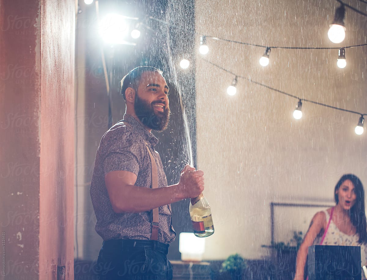 "A Man Splashing Sparkling Wine" by Stocksy Contributor "Lumina" - Stocksy