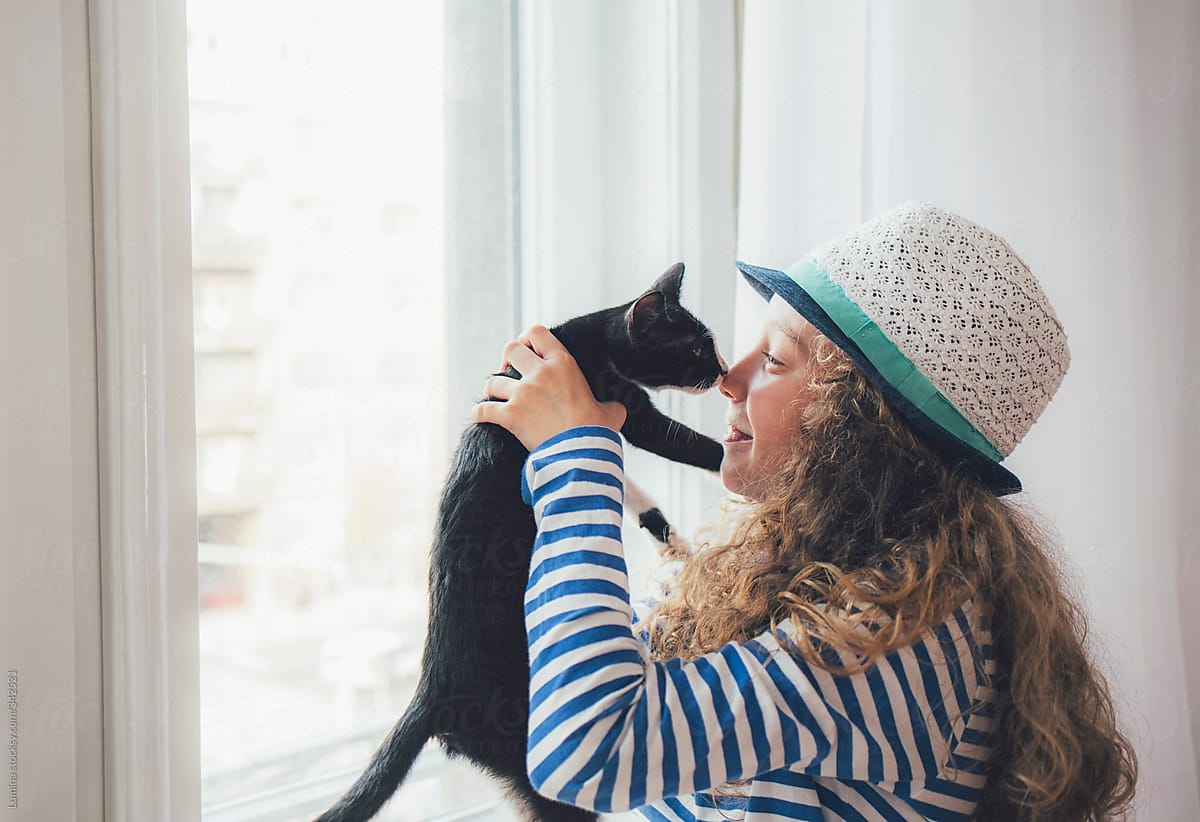 "Smiling Girl Playing With Her Kitten" by Stocksy Contributor "Lumina ...