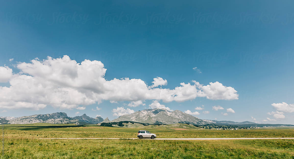 "Car On Countryside Road" by Stocksy Contributor "Lumina" - Stocksy