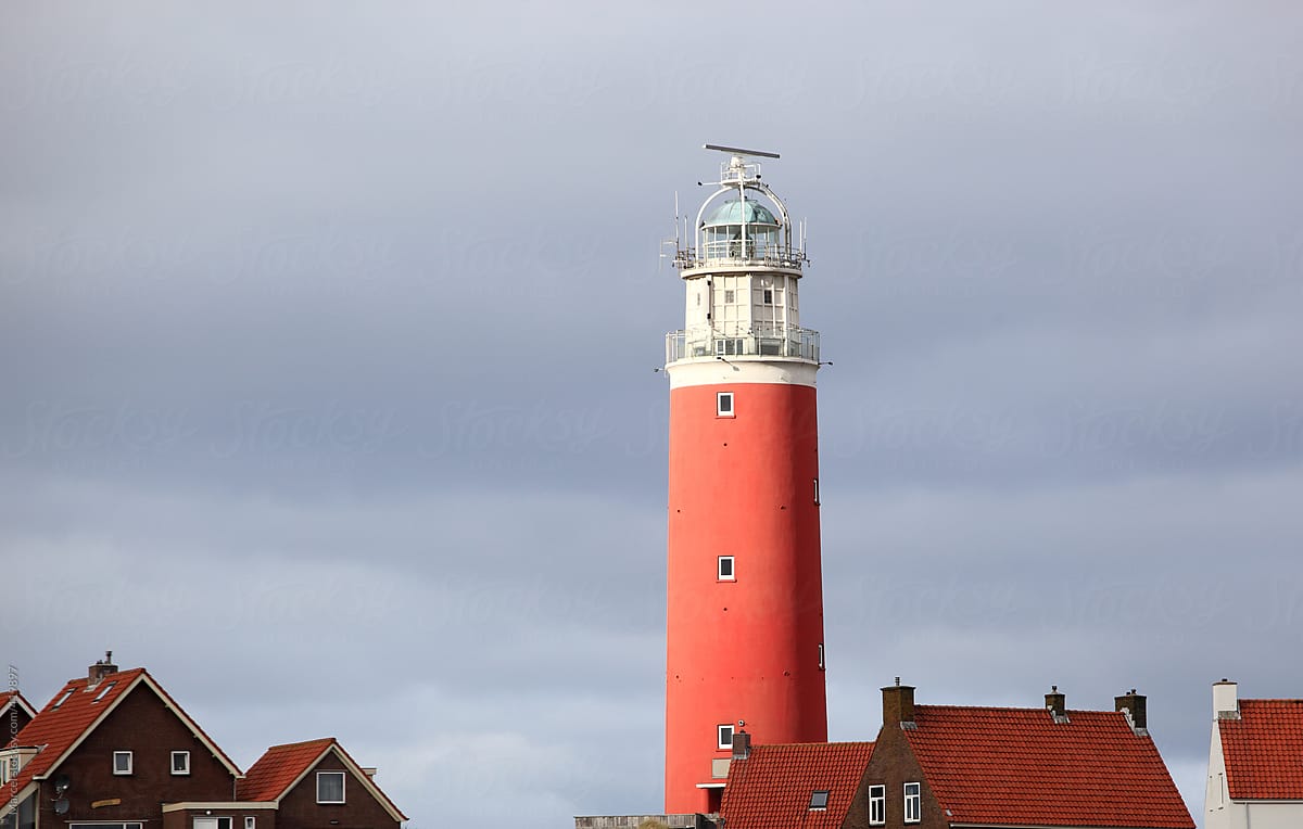 "Red Lighthouse In Late Sunlight" by Stocksy Contributor "Marcel" - Stocksy