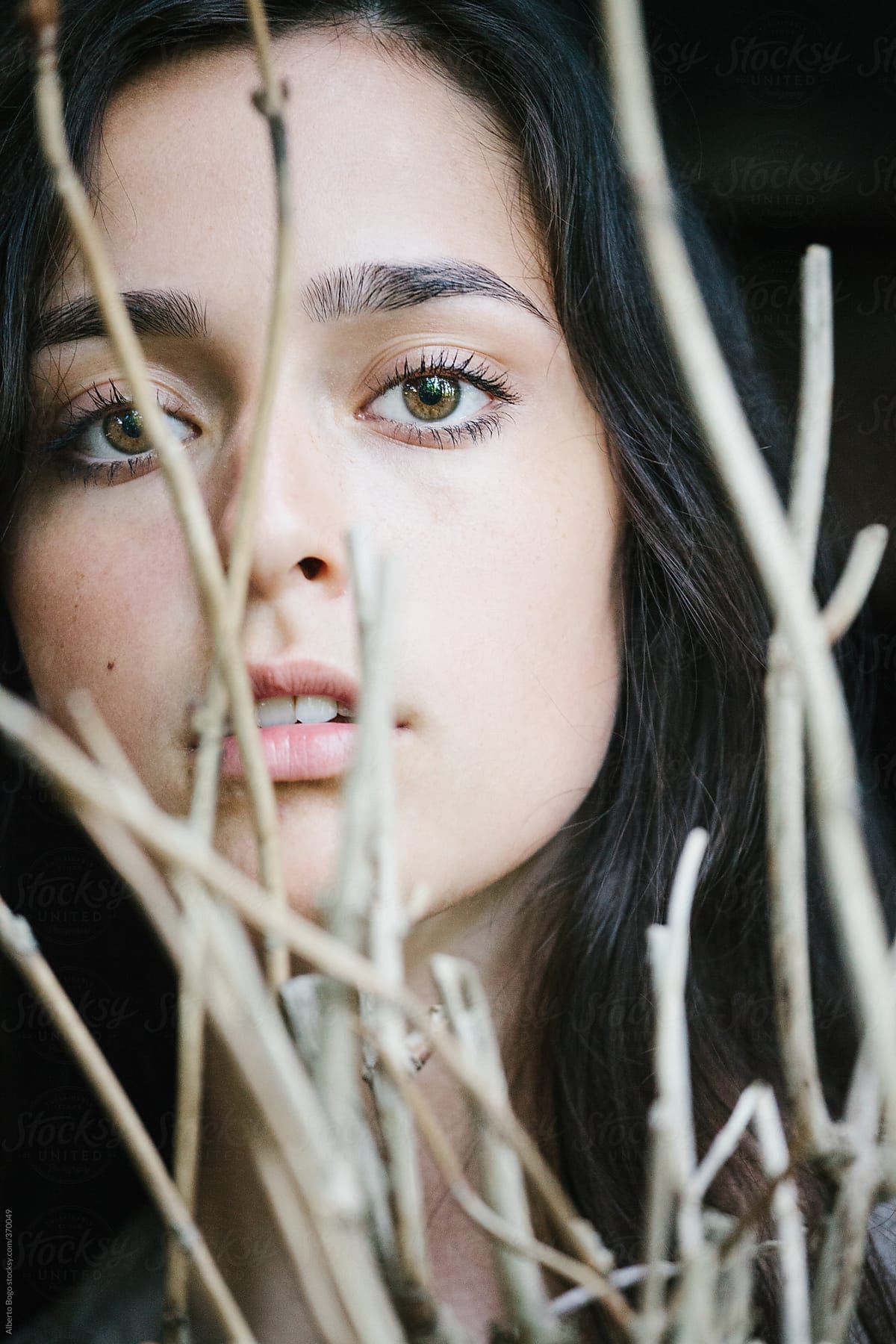 "Young Woman Looking Through Branch Of Tree" by Stocksy Contributor ...