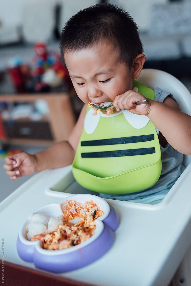 "Adorable Boy Eating At Home" by Stocksy Contributor "MaaHoo" - Stocksy