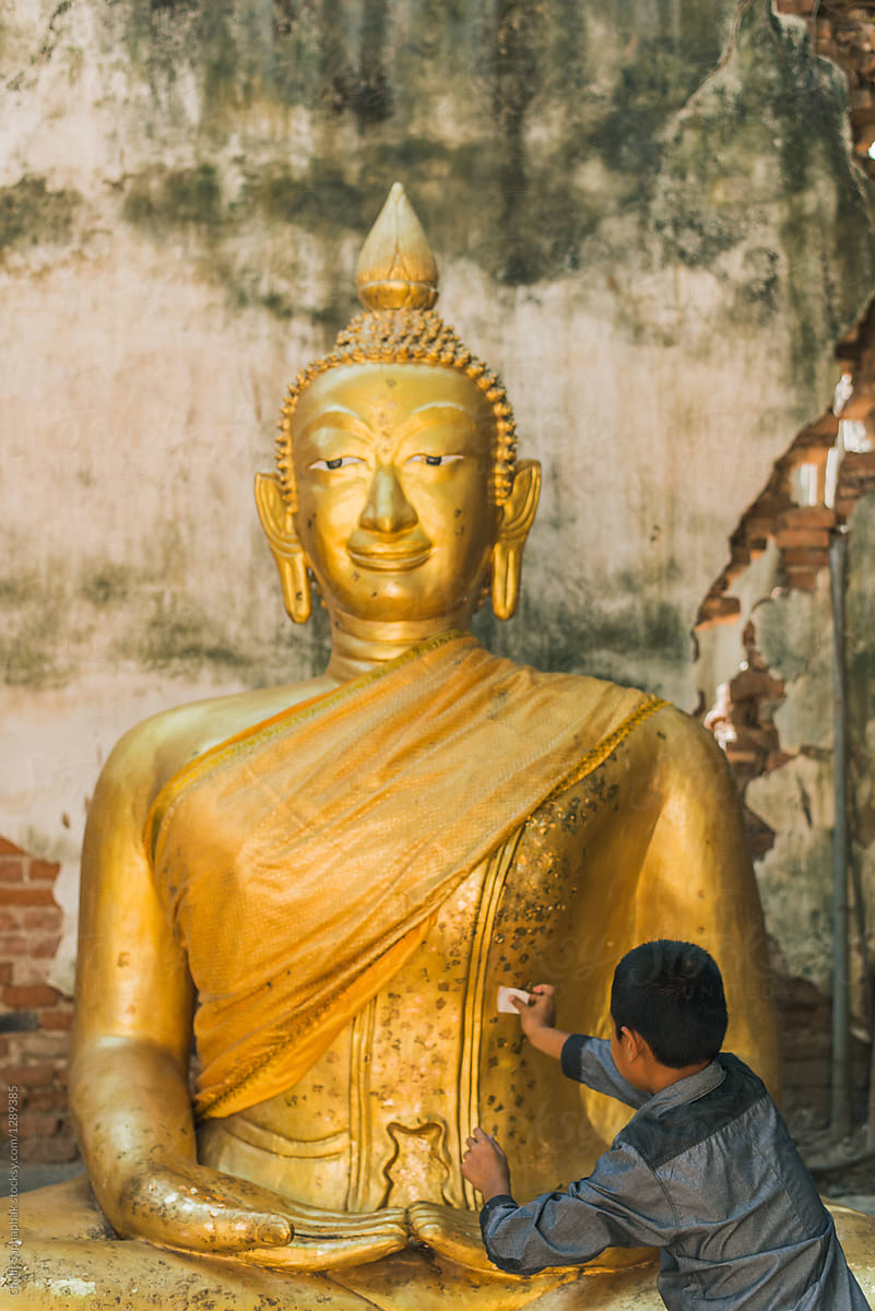 "Asian Boy Sticking Gold Leaf On Buddha Statue" by Stocksy Contributor ...
