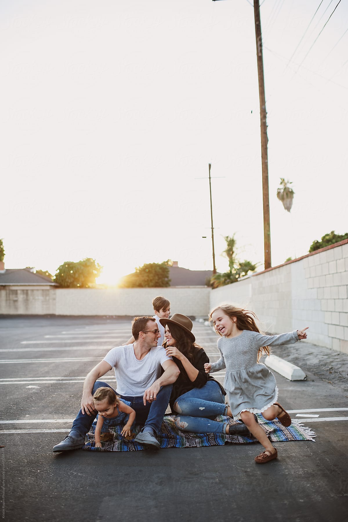 "Kids Running Around Parents" by Stocksy Contributor "Kristin Rogers ...