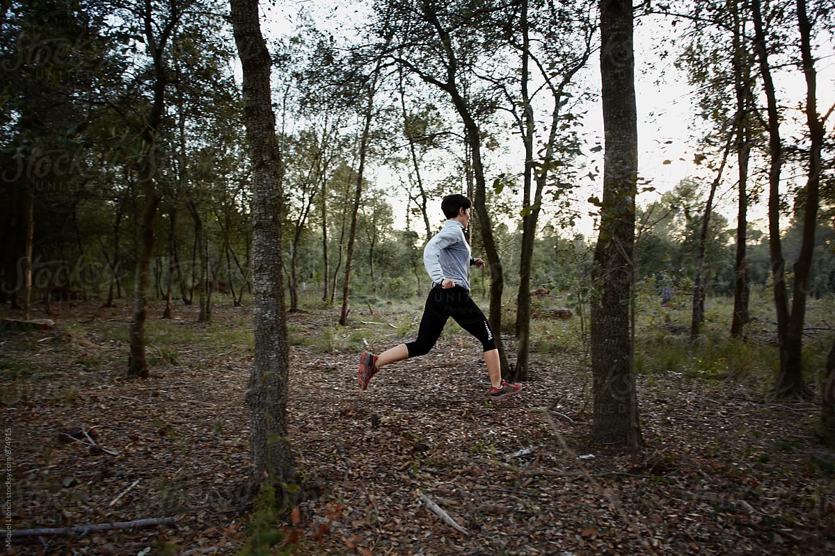"Female Running In A Forest" by Stocksy Contributor "Miquel Llonch ...