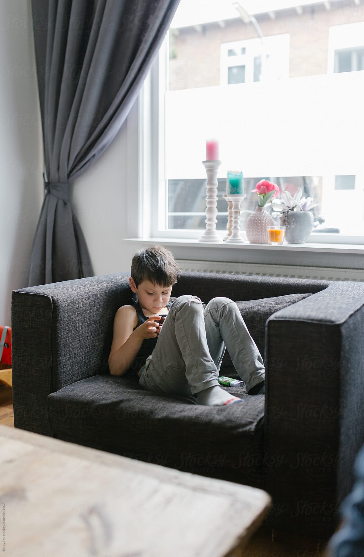 "Boy At Home" by Stocksy Contributor "Hillary Fox" - Stocksy