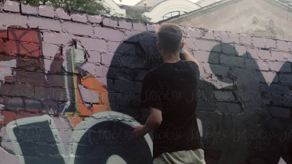 "Teen Painting A Graffiti On The Wall." by Stocksy Contributor "Luis ...