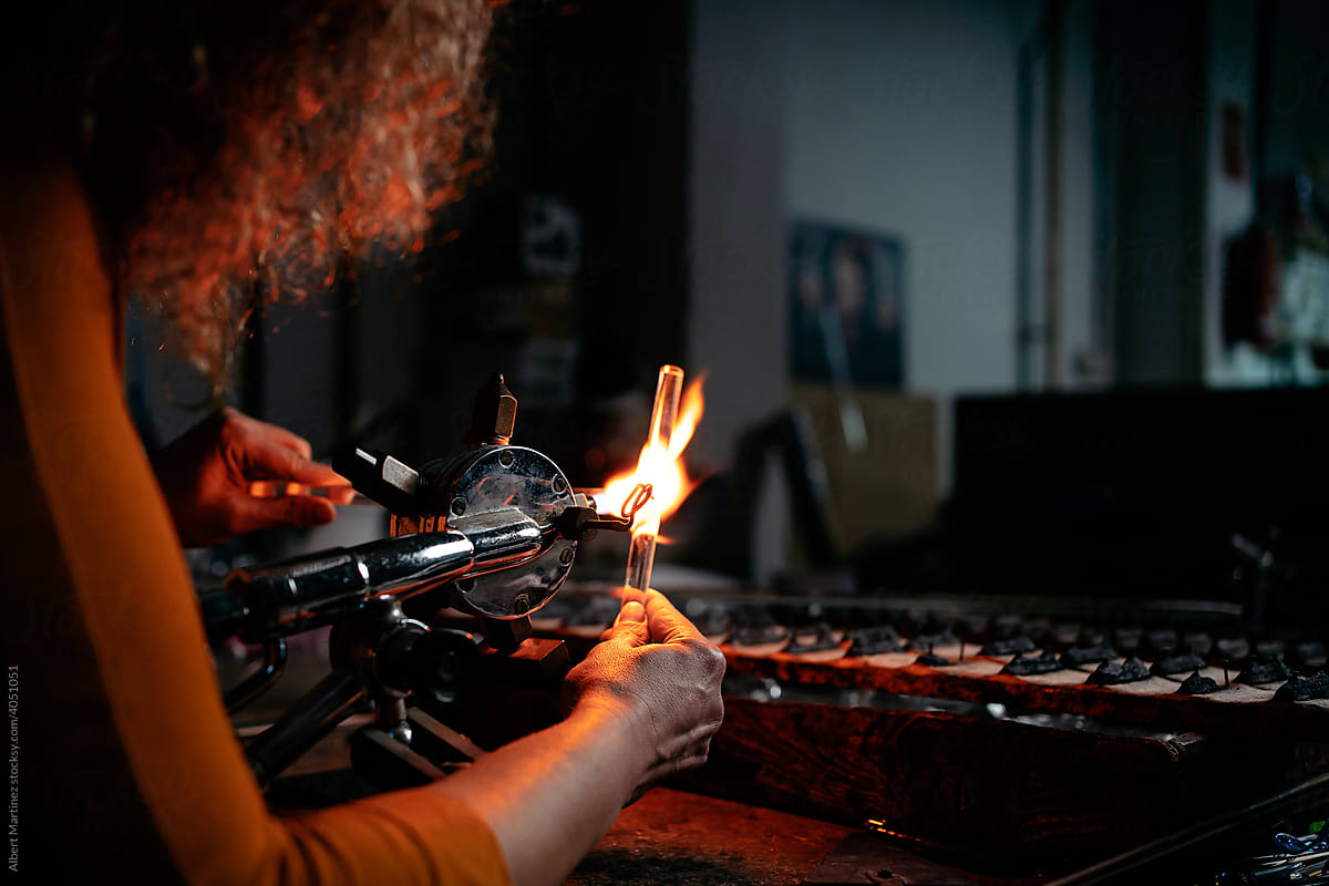 Close-up of two glass tubes being joined together with the torch flame ...