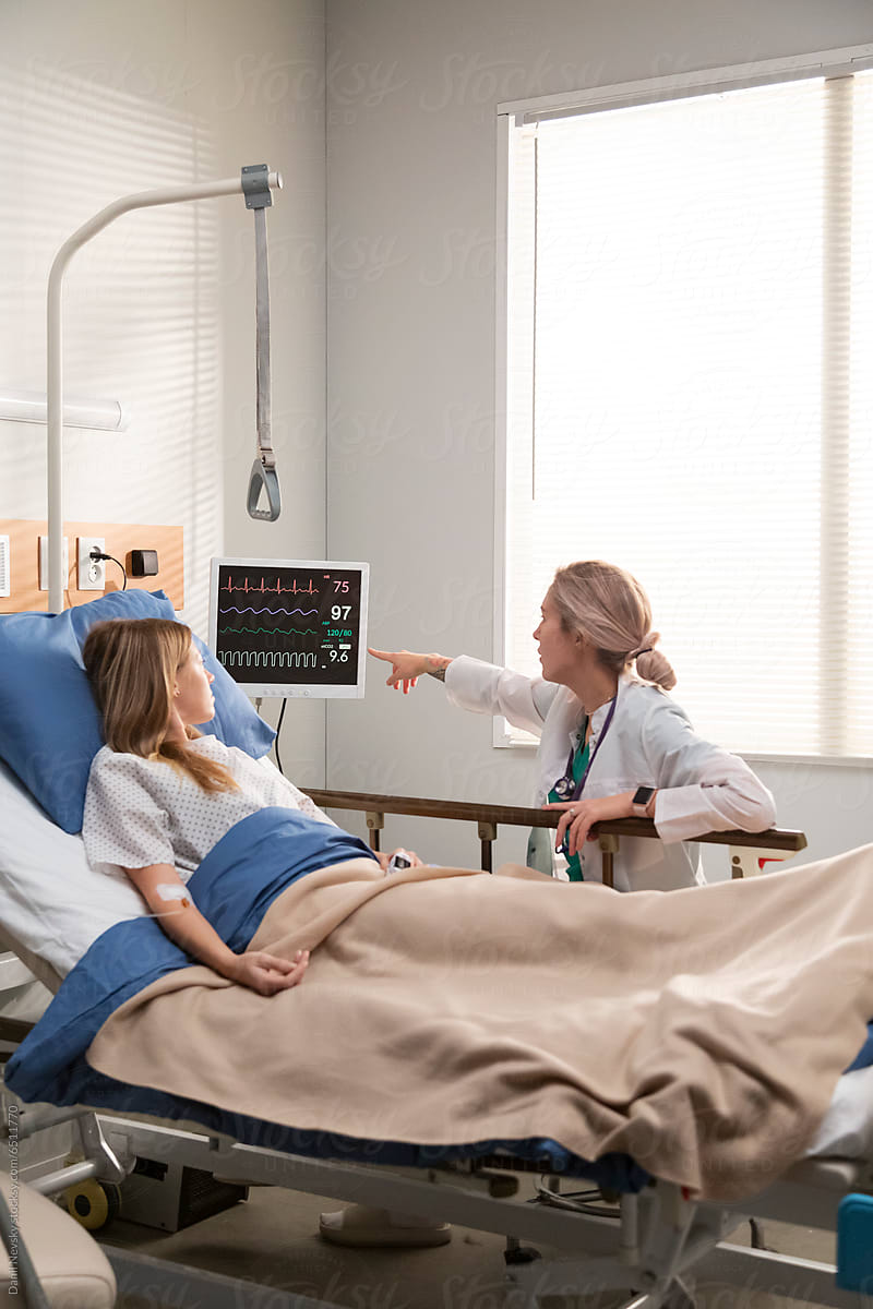"Female Doctor Explaining Medical Chart To Hospitalized Patient" by ...