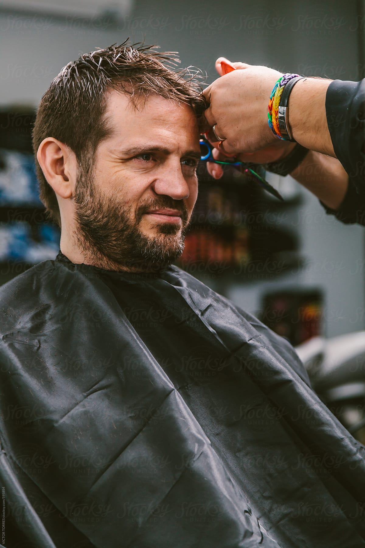 Barber Cutting Hair To A Client By Stocksy Contributor VICTOR TORRES barber-cutting-hair-to-a-client-by-stocksy-contributor-victor-torres