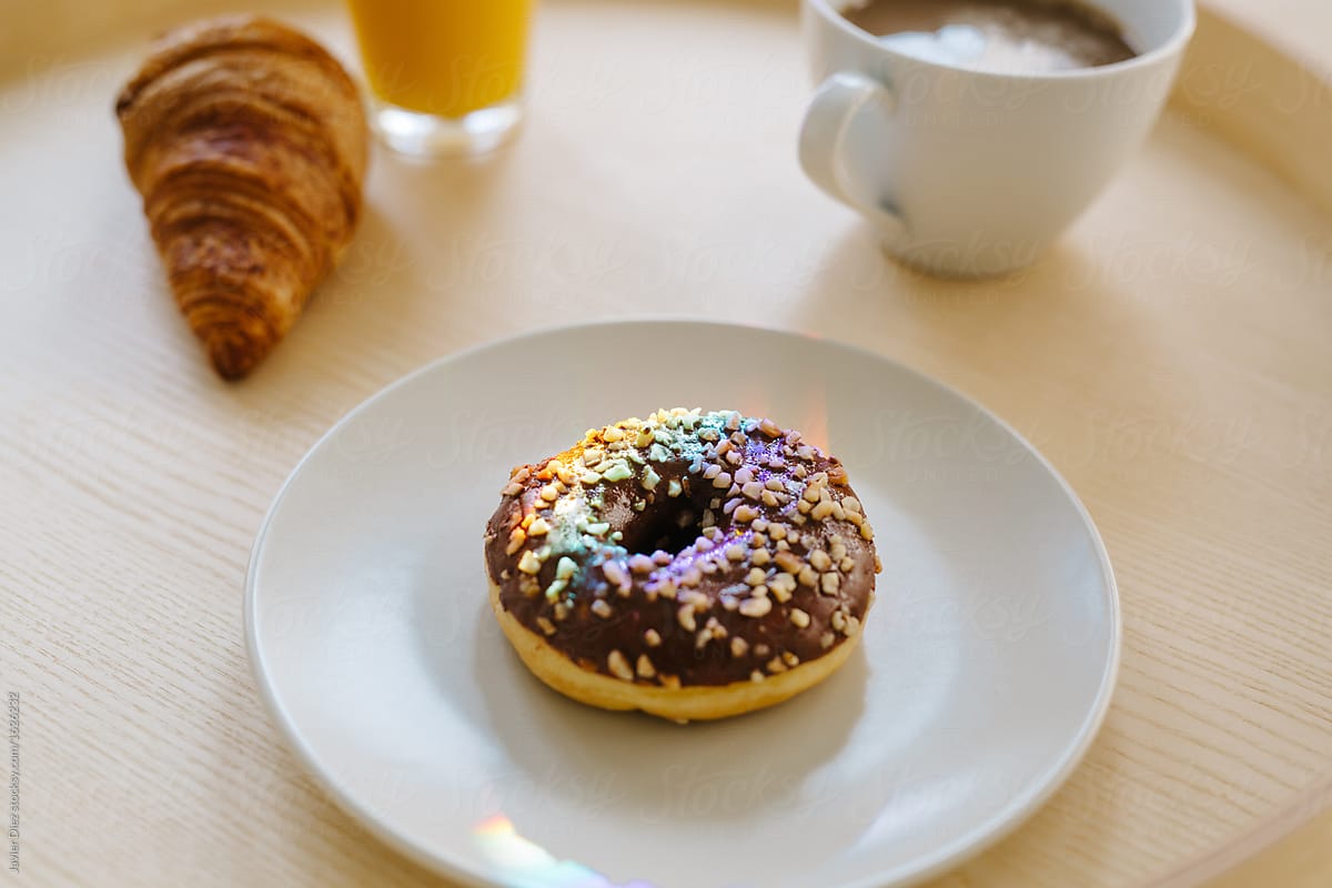 "Donut For Breakfast" by Stocksy Contributor "Javier Díez" - Stocksy
