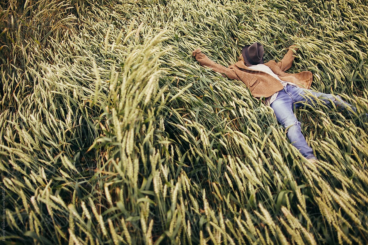 "Rustic Boy Laying In The Rye Field" by Stocksy Contributor "Evgenij ...