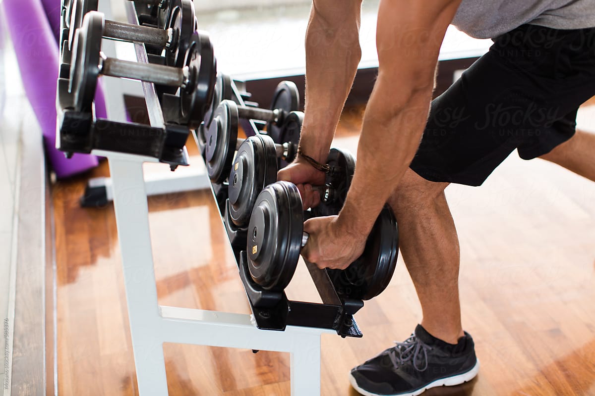 "Anonymous Man Lifting Weights In A Gym" by Stocksy Contributor "Mosuno ...