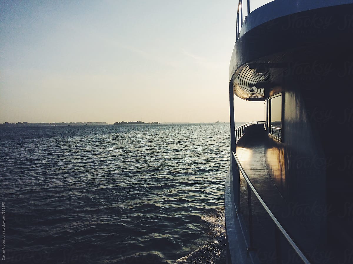 "Sunset Boat Journey" by Stocksy Contributor "Daxiao Productions" - Stocksy