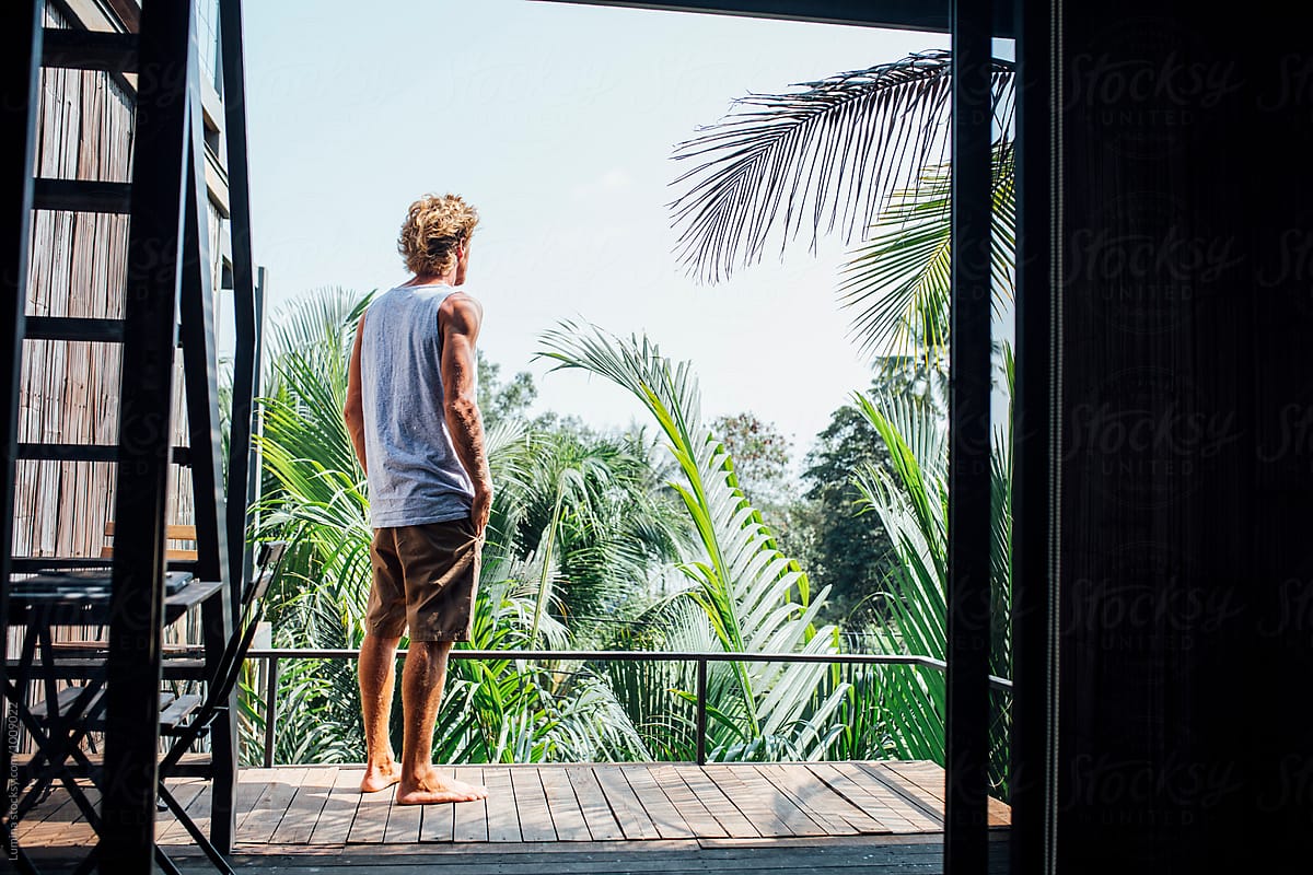 "Man Standing On The Balcony" by Stocksy Contributor "Lumina" - Stocksy