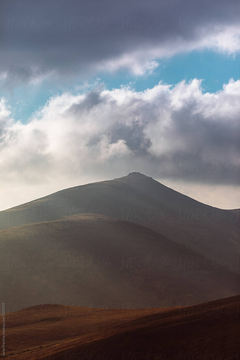 "Landscape With Sunset Clouds Between Mountains." by Stocksy ...