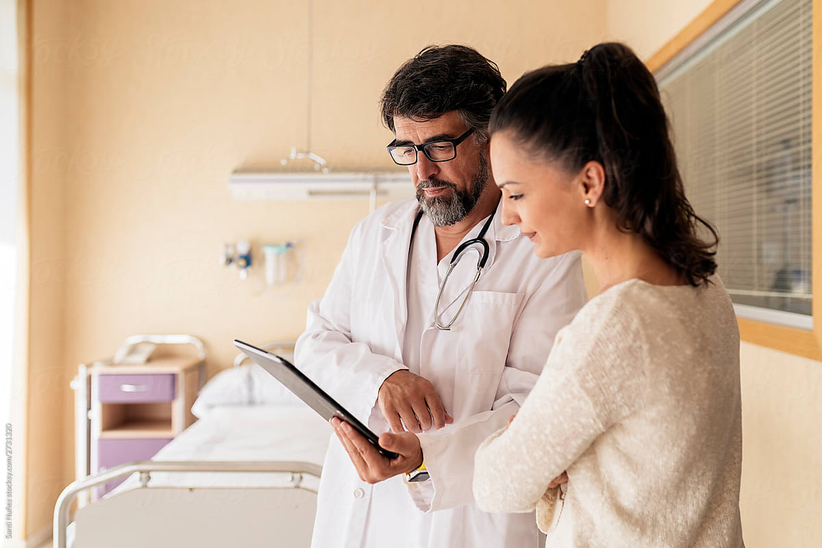 "Doctor And Patient Mother Watching Tests In A Tablet" by Stocksy ...