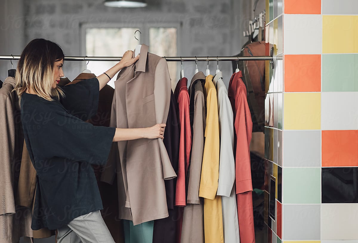 "Woman Taylor Looking At Clothes" by Stocksy Contributor "Lumina" - Stocksy