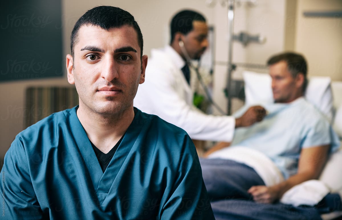 "Hospital: Serious Medical Assistant In Patient Room" by Stocksy ...