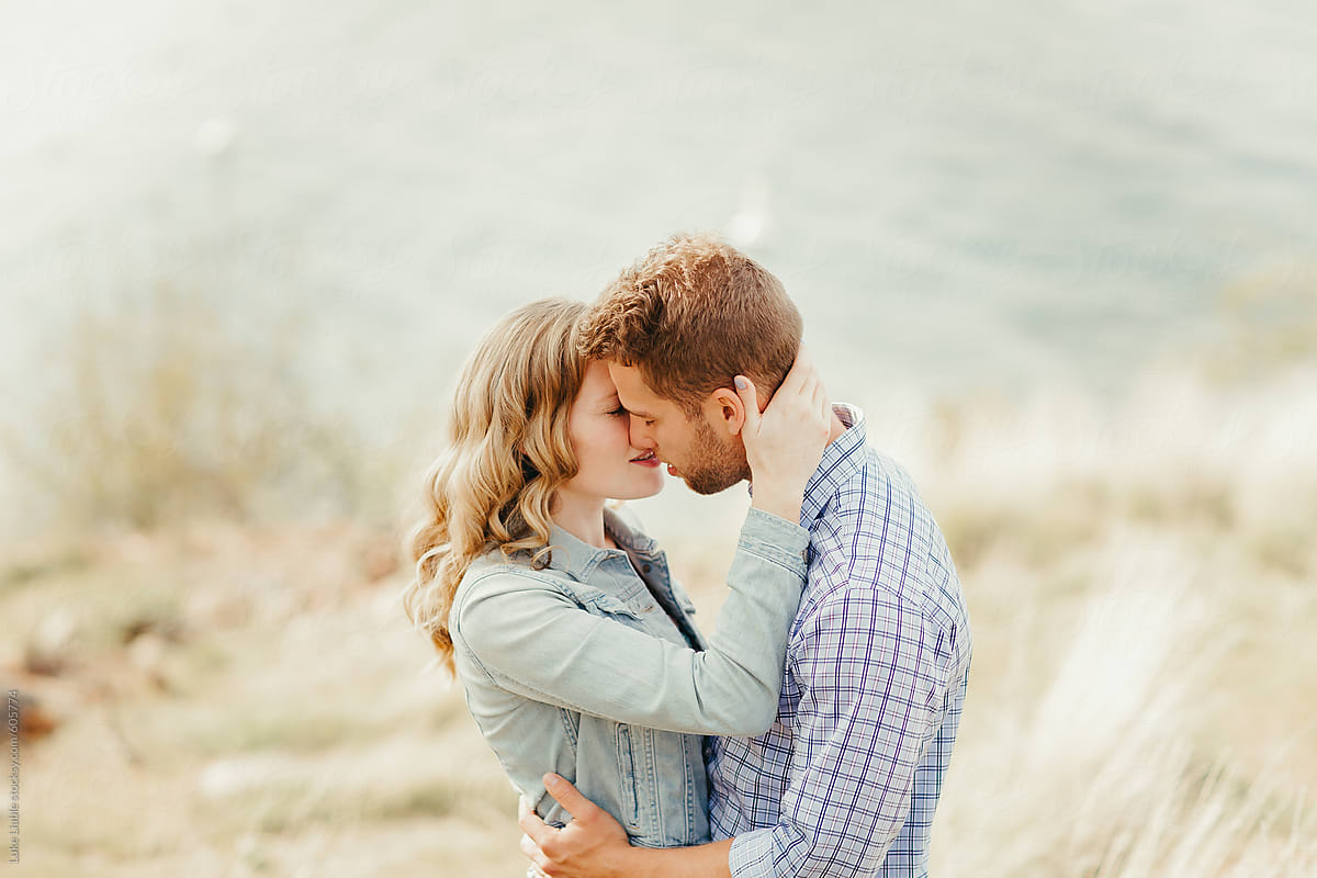 "Young Attractive Couple Kissing" by Stocksy Contributor "Luke Liable ...