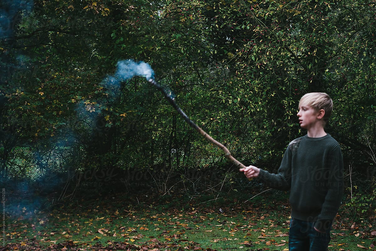 "A Boy Holding A Smoking Stick" by Stocksy Contributor "Helen Rushbrook ...