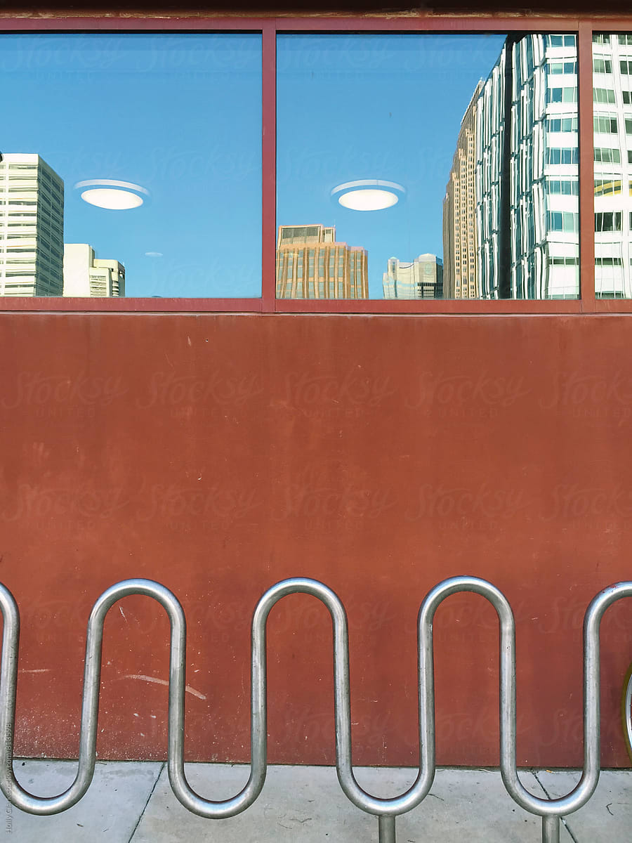 "Curved Bike Rack In Front Of Red Wall" by Stocksy Contributor "Holly ...