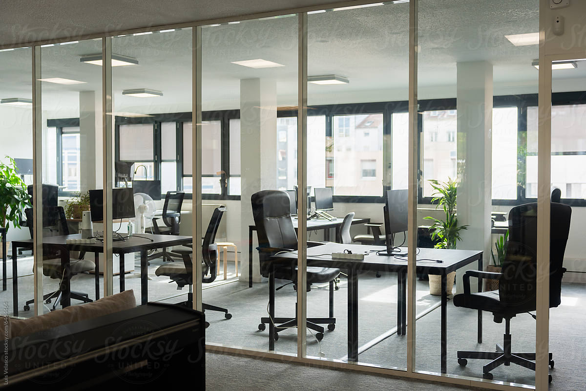 "Modern Open-Plan Office With Glass Partitions And Desks" by Stocksy ...