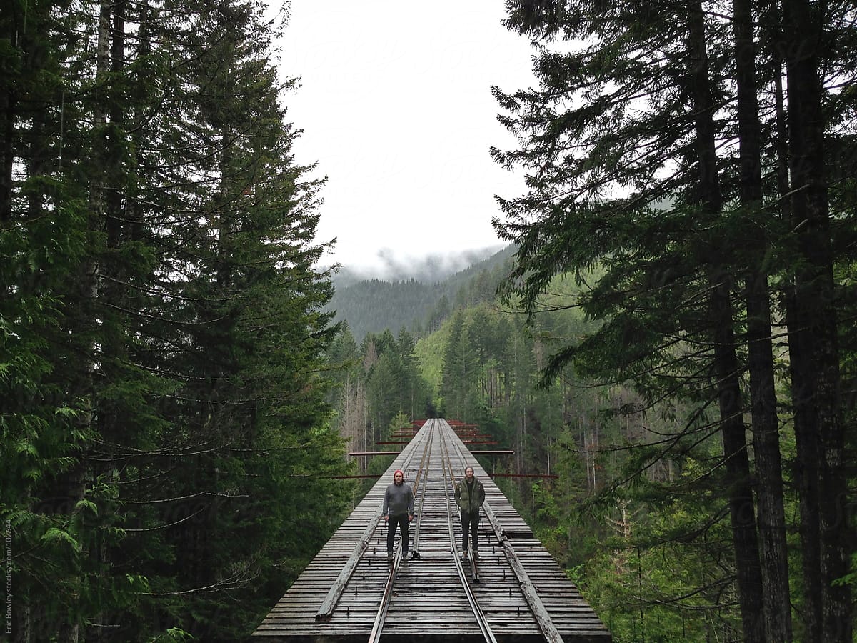 "Two Men Stand On High Steel Bridge" by Stocksy Contributor "Eric ...