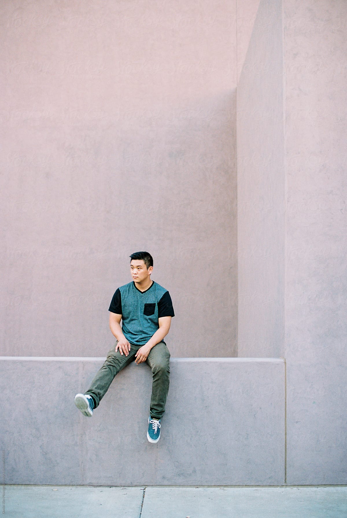 "Young Man Sitting On A Wall" by Stocksy Contributor "Daniel Kim ...