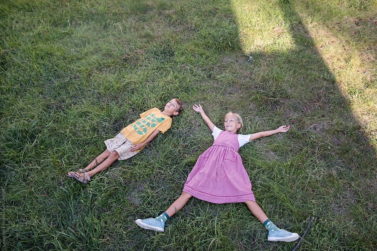 "Kids On The Lawn In Summer" by Stocksy Contributor "Evgenij Yulkin ...