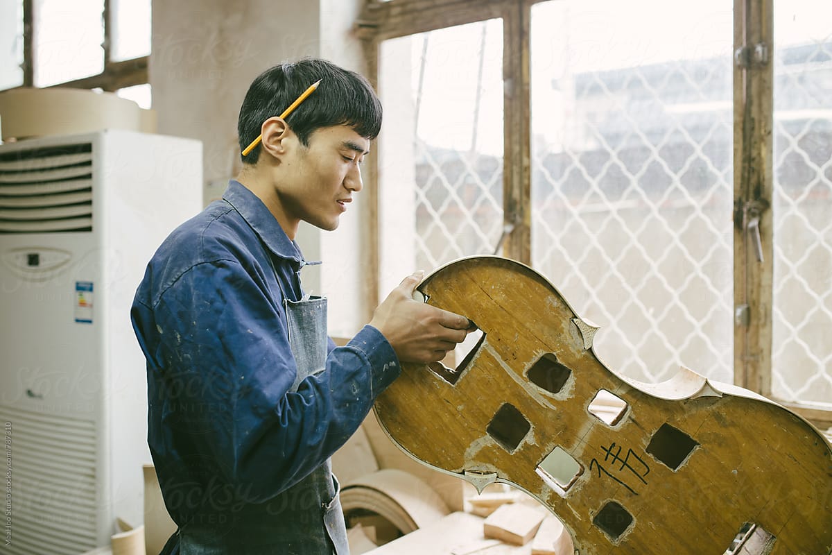 "Violoncello Maker At Work" by Stocksy Contributor "MaaHoo" - Stocksy
