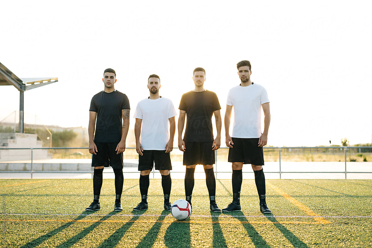 "Soccer Team Near Ball" by Stocksy Contributor "Javier Díez" - Stocksy