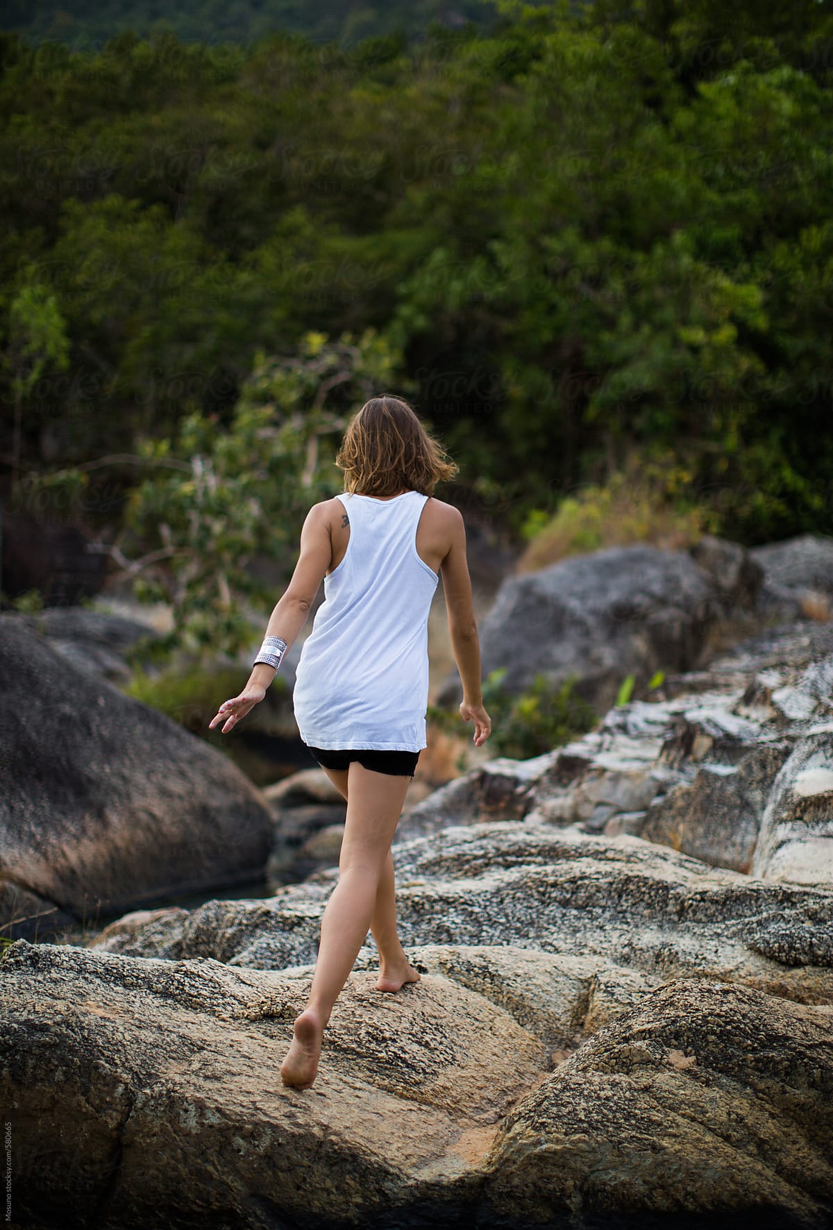 "Woman Walking On The Rocks" by Stocksy Contributor "Mosuno" - Stocksy
