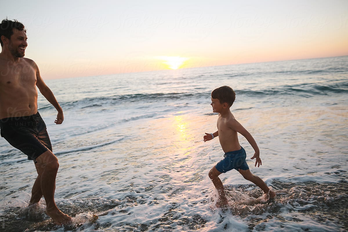 "Energetic Dad Playing With Kids On The Beach At Sunset" by Stocksy ...