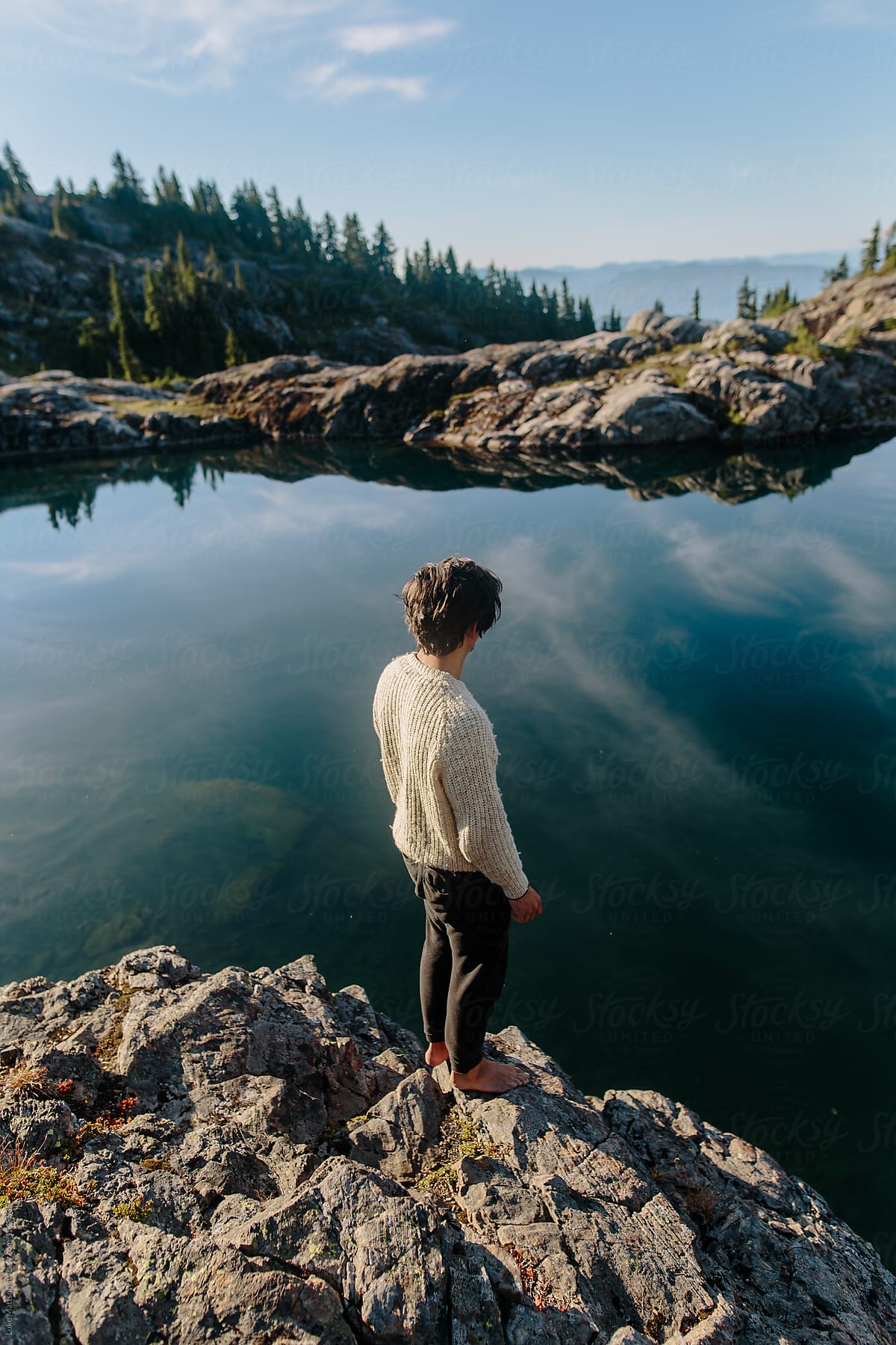 "Man Looking Over Clear Mountain Lake" by Stocksy Contributor "Luke ...