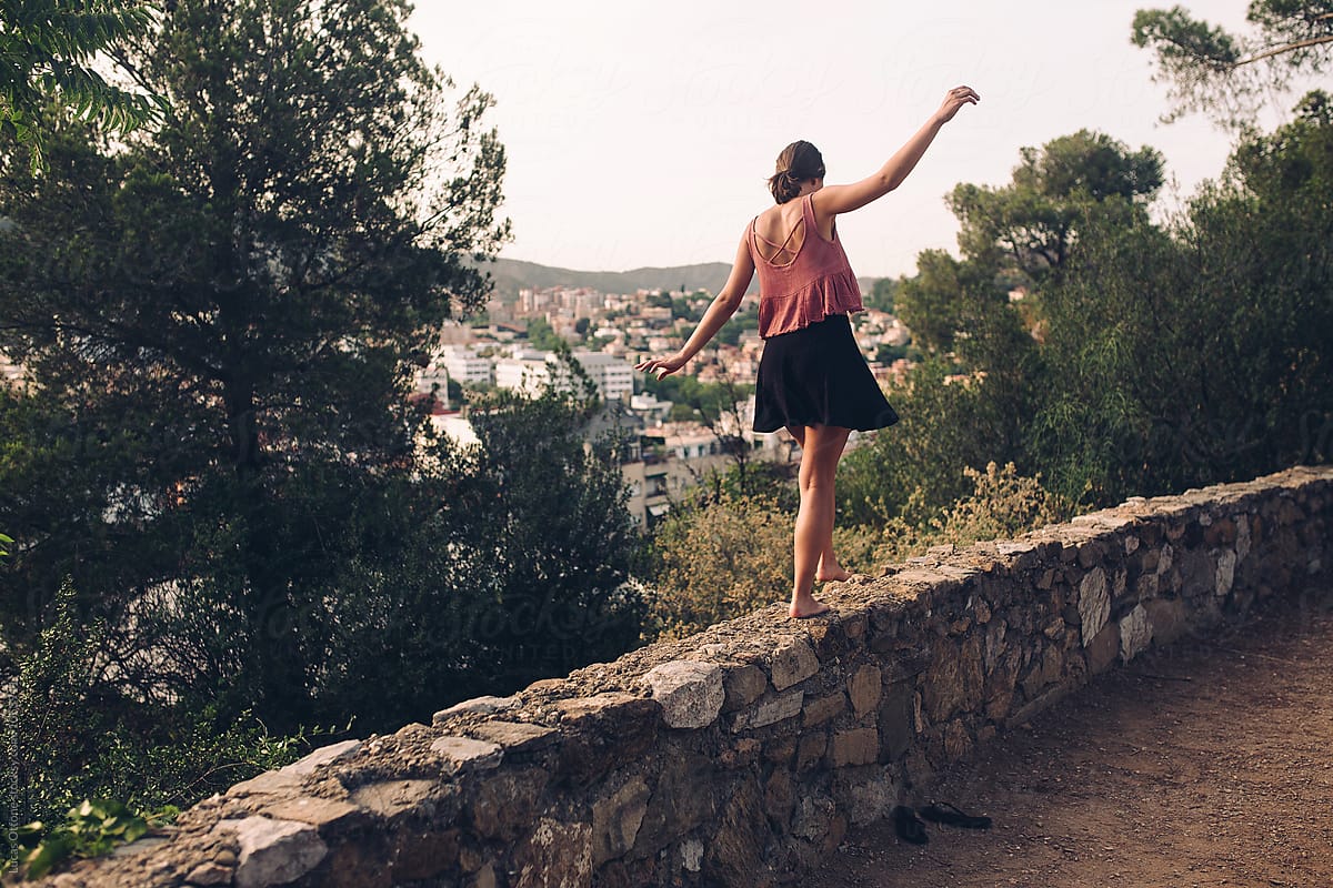 "Young Woman Walking Over A Rock Wall" by Stocksy Contributor "Lucas ...